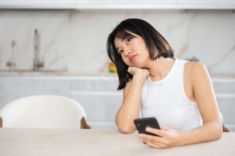 Sad Young Asian Girl Sitting Kitchen Table Smartphone Hand Stock Photos ...