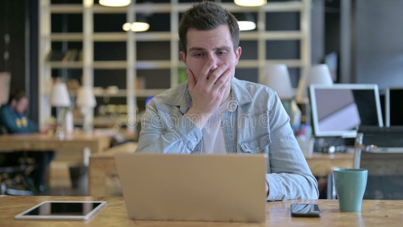 Sad Young Designer Facing Loss on Laptop in Modern Office Stock Footage ...
