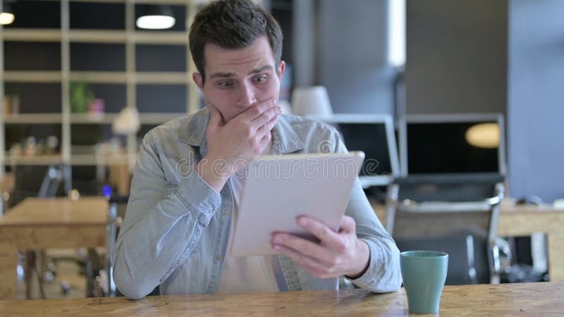 The Sad Young Designer Facing Loss on Tablet in Office Stock Photo ...