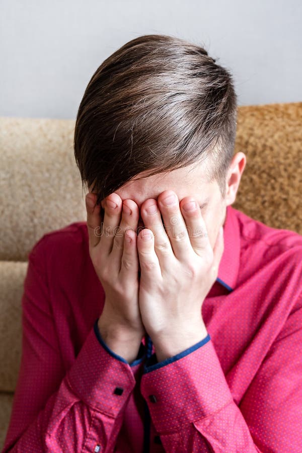 Sad Young Man stock photo. Image of divan, home, crying - 264986138
