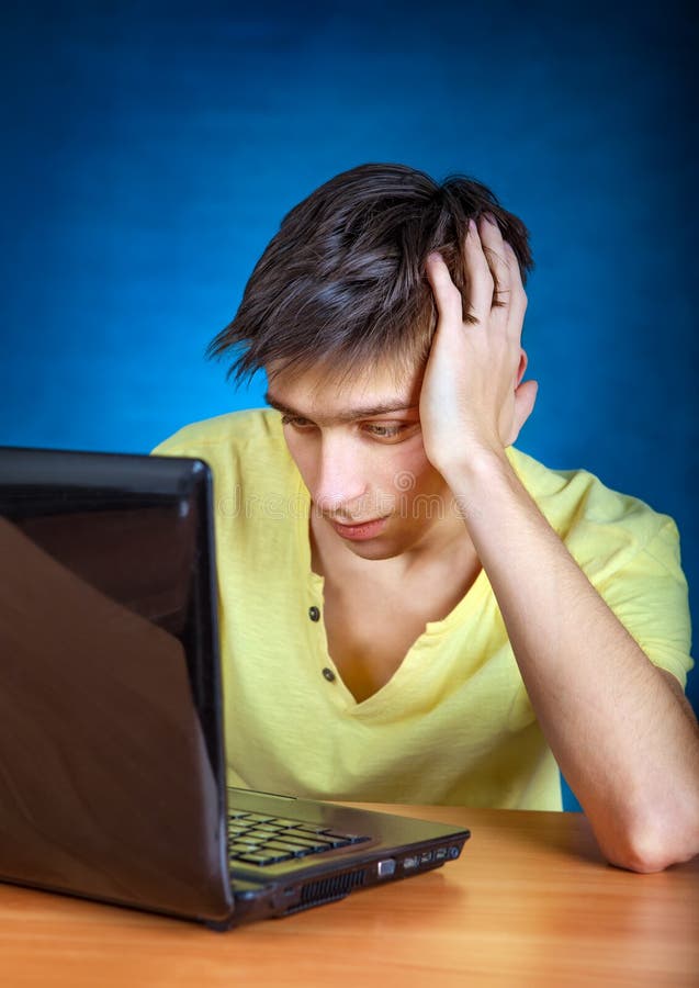 Sad Young Man with Laptop stock photo. Image of problem - 69480008
