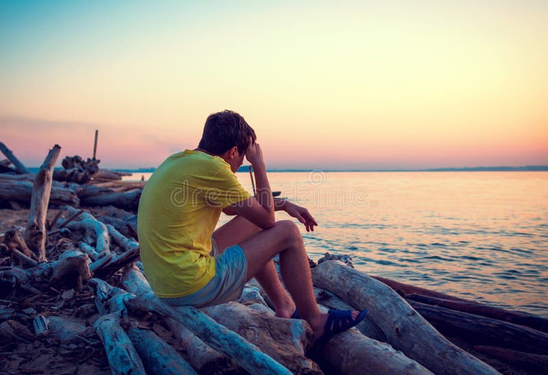 Sad Young Man outdoor stock photo. Image of evening - 101487328