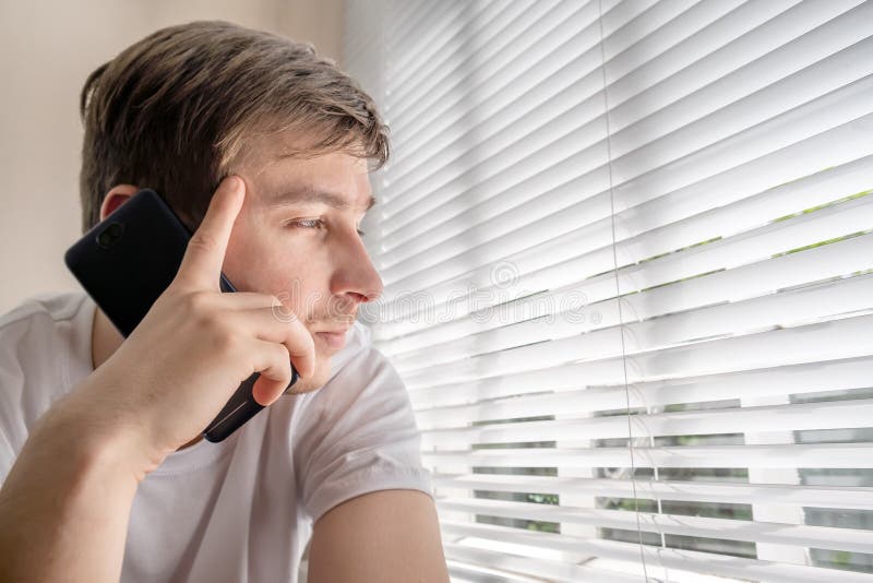 Sad Young Man with a Phone stock image. Image of jalousie - 254496169