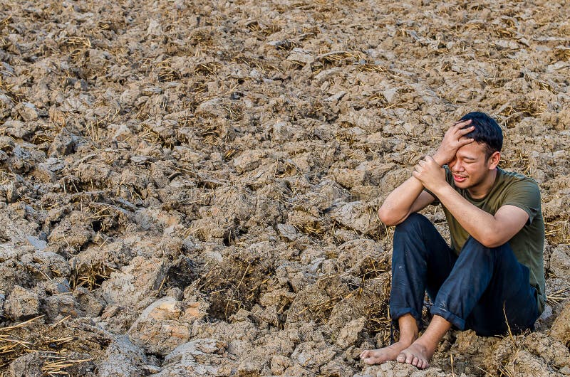 Sad Young Man Sitting in Barren Ground Stock Image - Image of ...