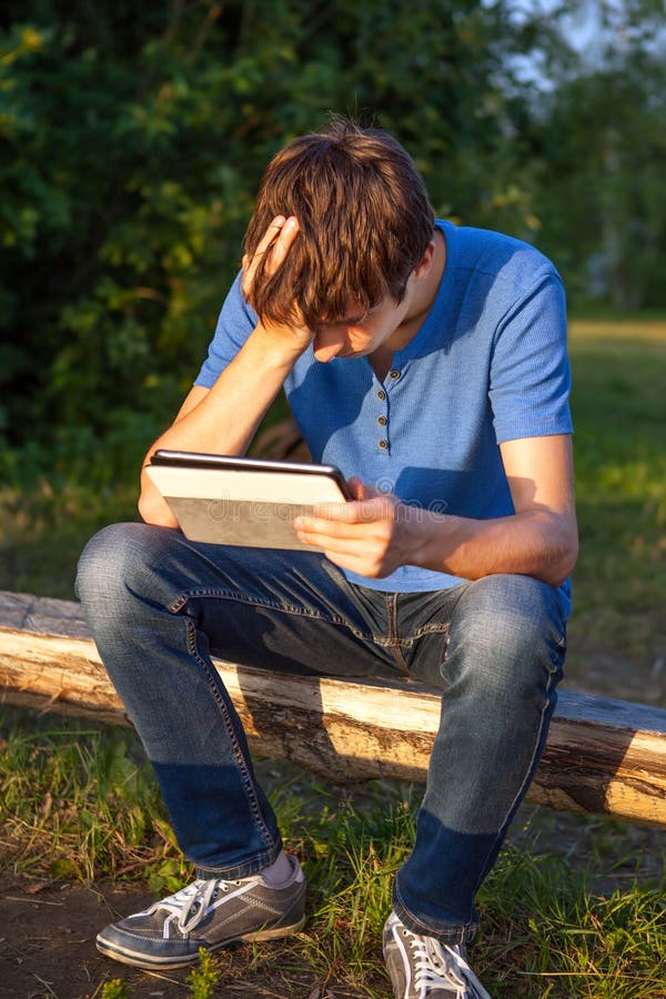 Sad Young Man with Tablet stock photo. Image of gadget - 70035600