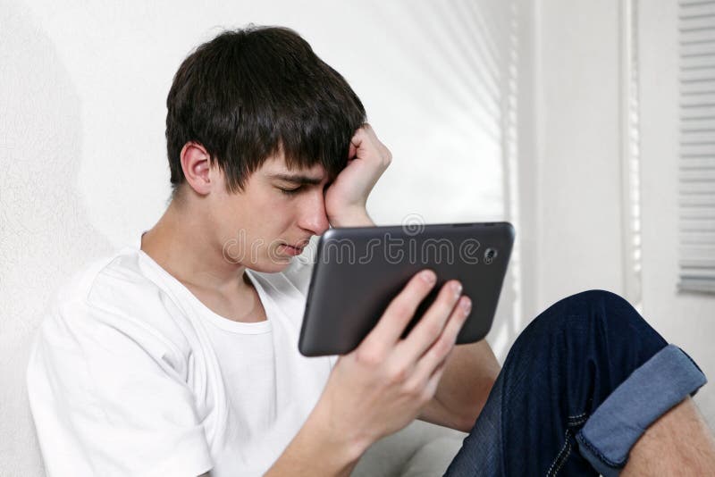 Sad Young Man with Tablet stock image. Image of sadness - 34746265