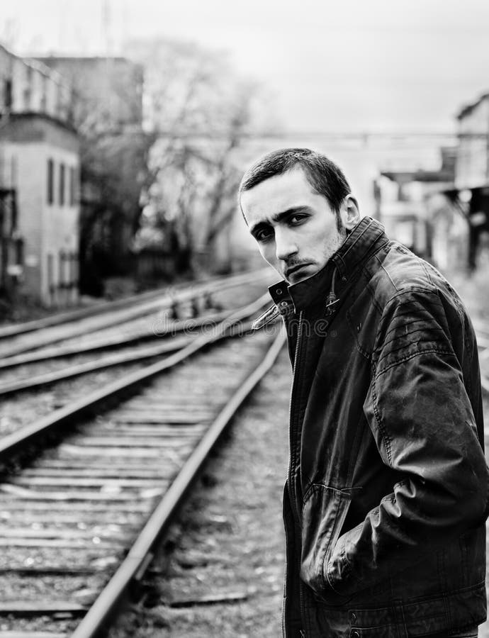 Sad Young Man Waiting for the Train among Industrial Ruins Stock Photo ...