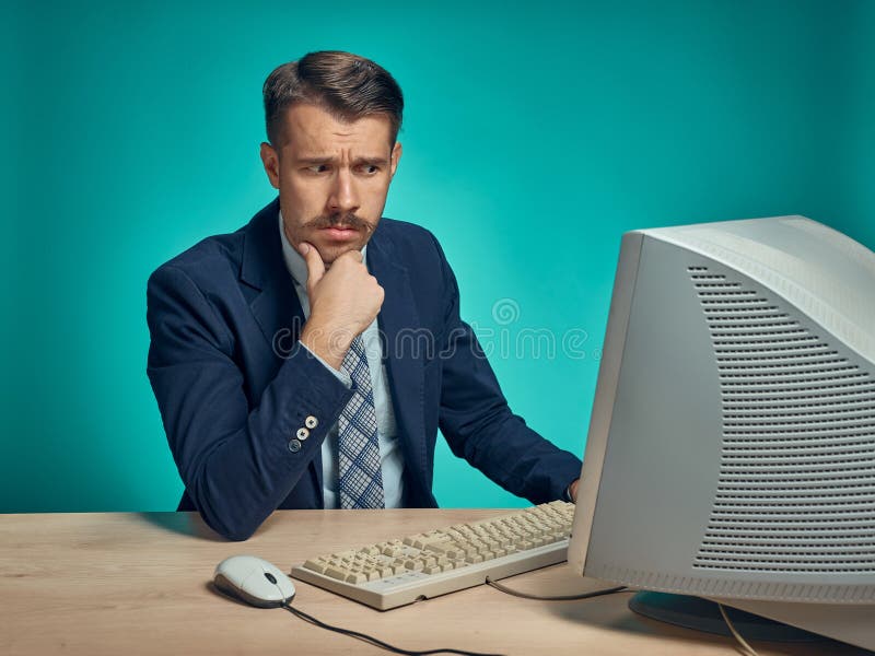 Sad Young Man Working on Computer at Desk Stock Photo - Image of ...