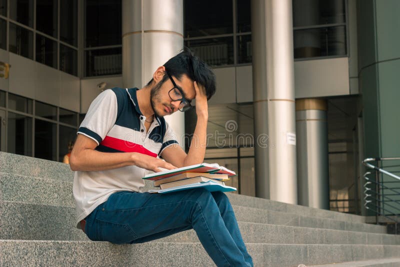 Sad Young Student Boy Sits on a Stairs and Read Book Stock Image ...