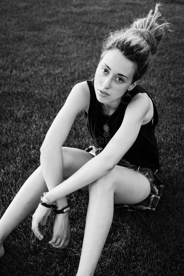 Sad Young Woman with Dreadlocks Sitting on the Ground. Stock Image ...