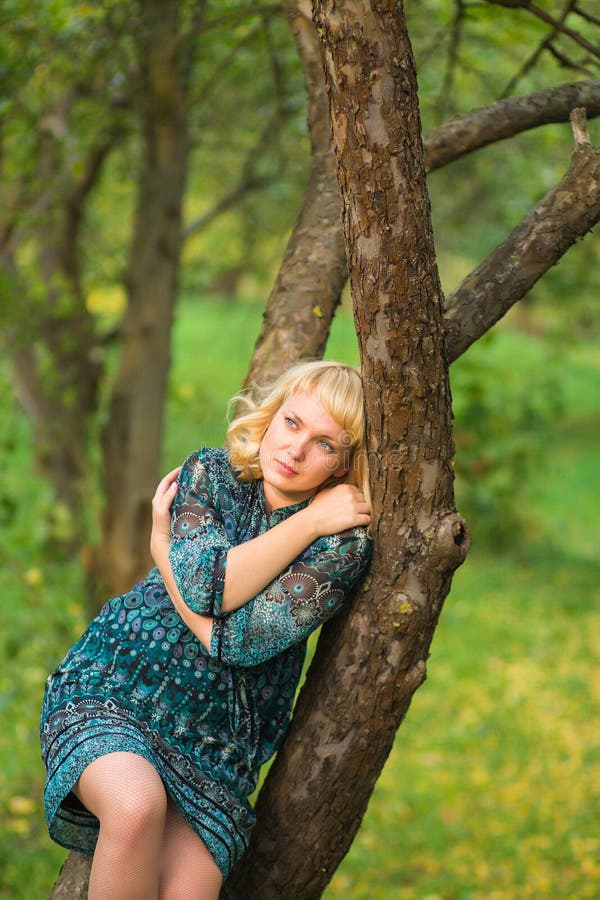 Sadness Girl Sitting on a Tree Branch Stock Photo - Image of sitting ...