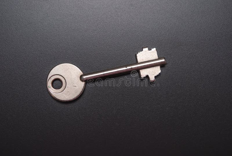 A Safe Key, a Smaller Safe Key Against a Dark Background Stock Photo ...