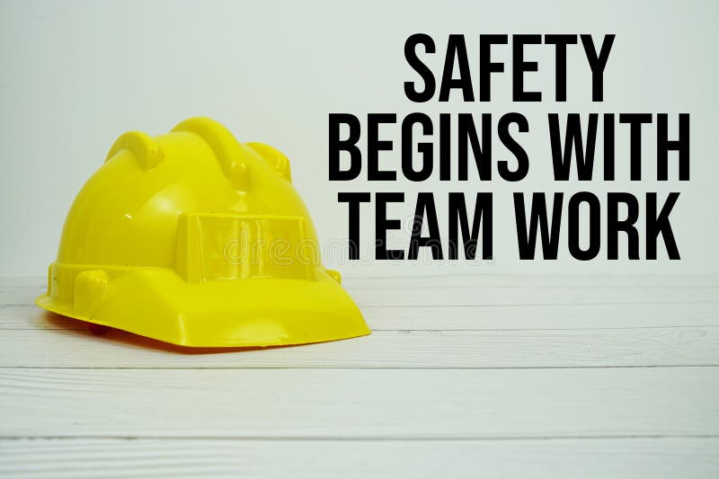 Safety Begins with Team Work Text on Blackboard with Safety Helmet on ...
