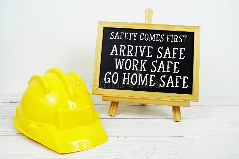 Safety Come First Text on Blackboard with Safety Helmet on Wooden ...