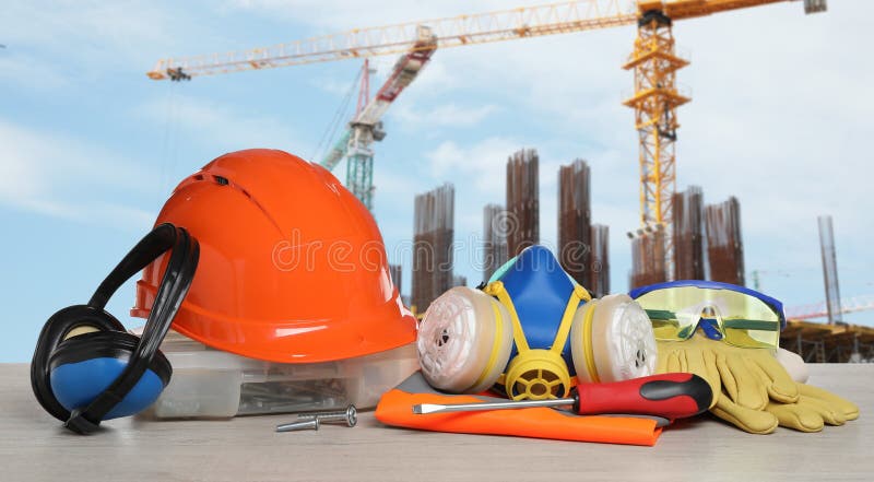 Safety Equipment and Tools on Wooden Surface and Blurred View of ...