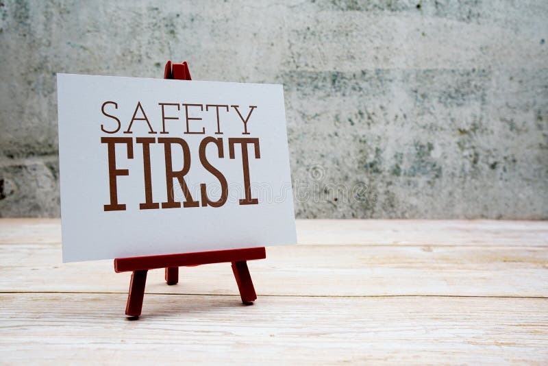 Safety First Text on Paper Card on Wooden Background Stock Image ...