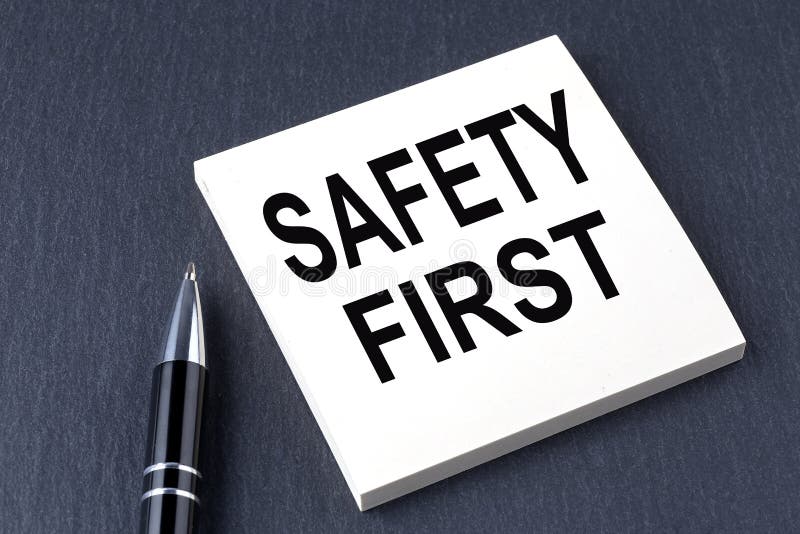 SAFETY FIRST Text on the Sticker with Pen on the Black Background Stock ...