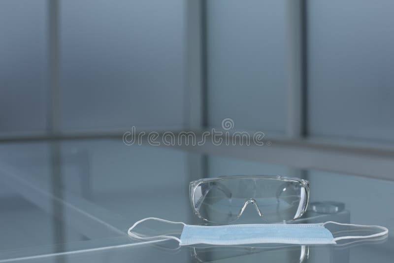 Safety Goggles and Protective Mask on Glass Table Stock Photo - Image ...