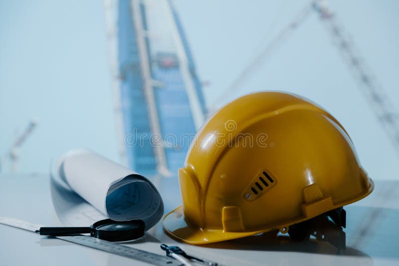Safety Helmet Hat and Projects of Construction Site Building on a Table ...
