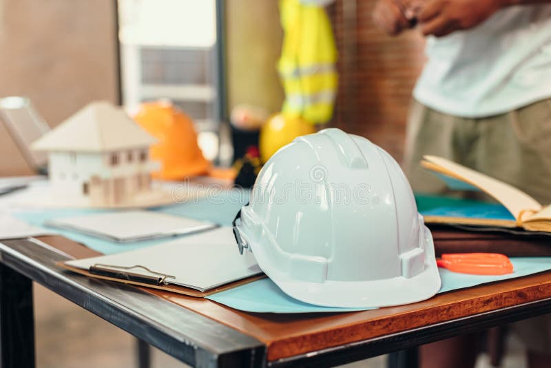 Safety Helmets on the Table at Site Construction. Architect, Engineer ...