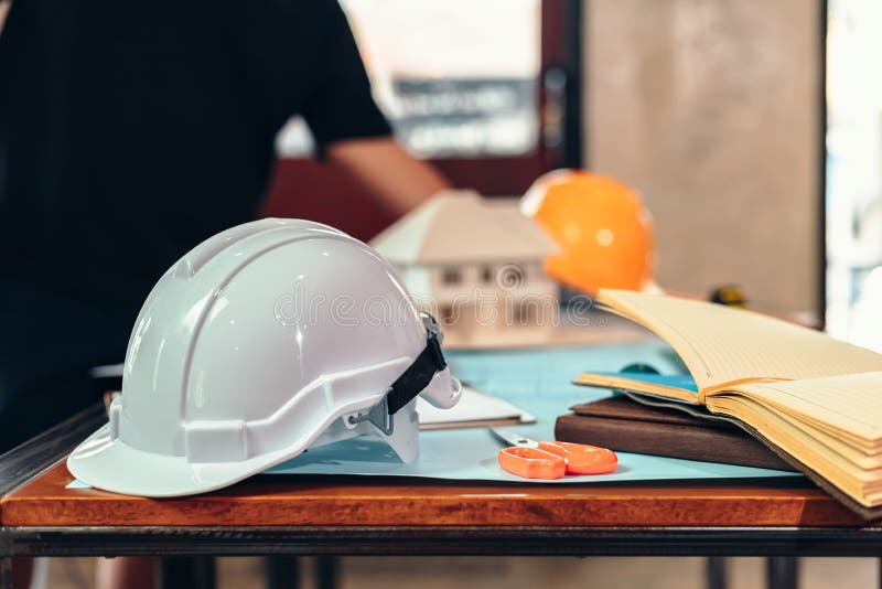 Safety Helmets on the Table at Site Construction. Architect, Engineer ...