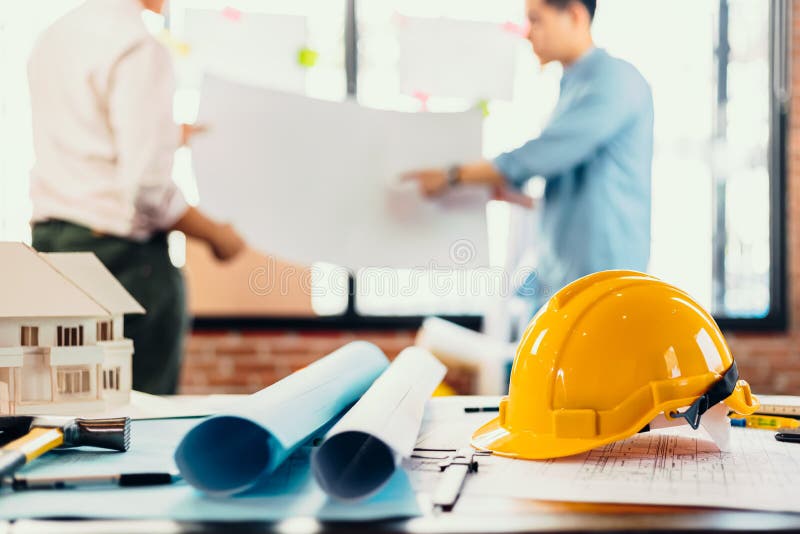 Safety Helmets on the Table at Site Construction. Architect, Engineer ...