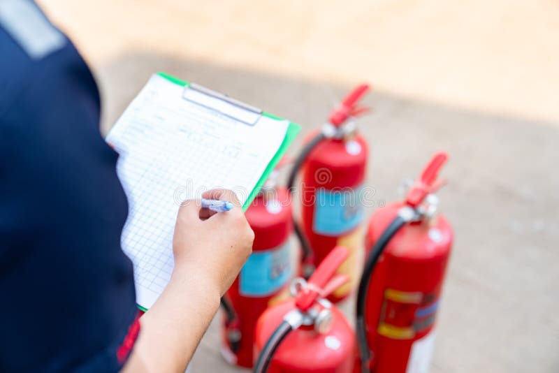 A Safety Officer is Performing the Monthly Fire Extinguisher Inspection ...