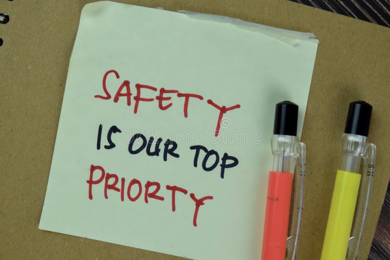 Safety is Our Top Priority Write on Sticky Notes Isolated on Wooden ...