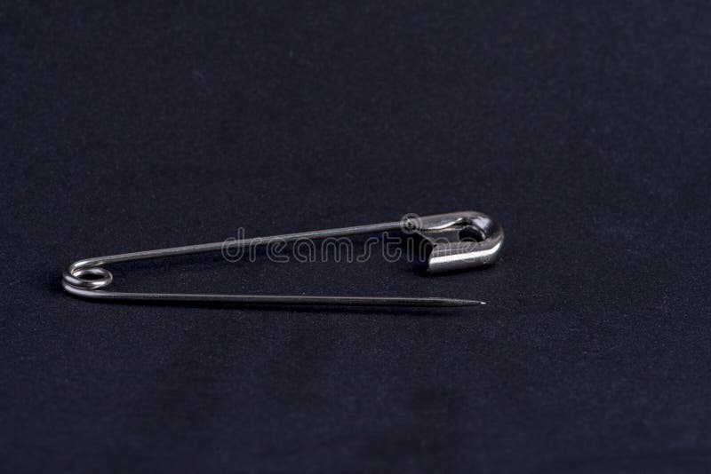 Safety Pin on Black Background with Text Space Stock Photo - Image of ...