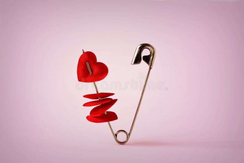 Safety Pin with Hearts on Pink Background - Concept of Love Stock Image ...