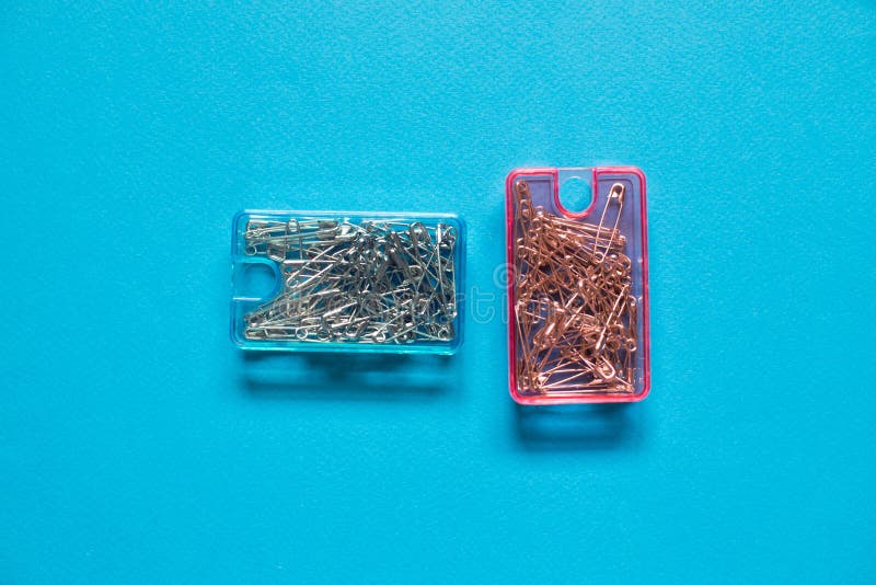 Safety Pins in Blue and Pink Plastic Boxes on Blue Background Stock ...