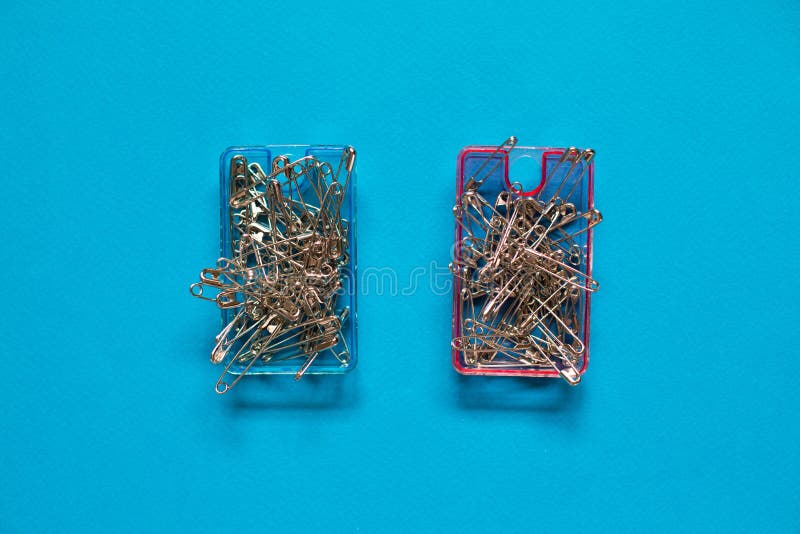 Safety Pins in Blue and Pink Plastic Boxes on Blue Background Stock ...