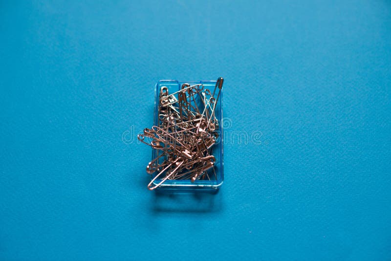 Safety Pins in Blue Plastic Box on Blue Background Stock Image - Image ...