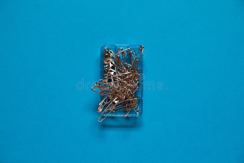 Safety Pins in Blue Plastic Box on Blue Background Stock Image - Image ...