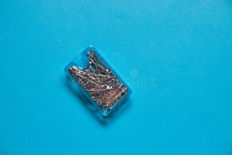 Safety Pins in Blue Plastic Box on Blue Background Stock Image - Image ...