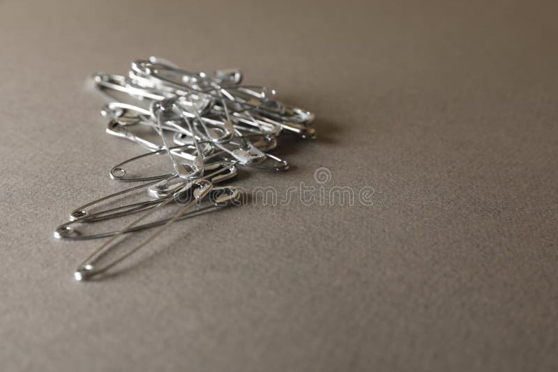 Safety Pins on Grey Textured Background, Closeup. Space for Text Stock ...
