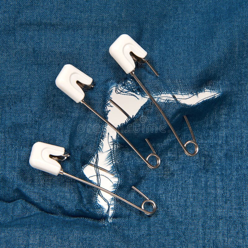 Safety Pins Holding Torn Fabric Stock Photo - Image of clothing, cyan ...