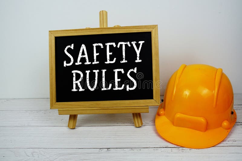 Safety Rules Text on Blackboard with Safety Helmet on Wooden Background ...