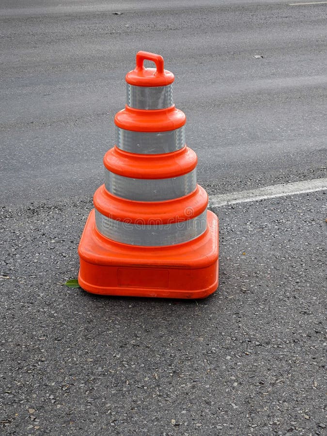 A Safety Traffic Cone on the Asphalt Road. Transportation Equipment ...