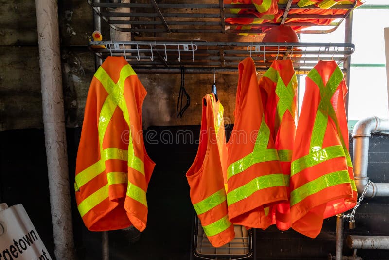 Safety Vests Hanging on Rack Stock Image - Image of architecture, vests ...