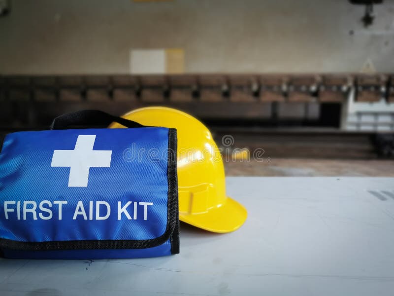 Safety at Work Concept. Helmet and First Aid Kit Bag on the Table Stock ...