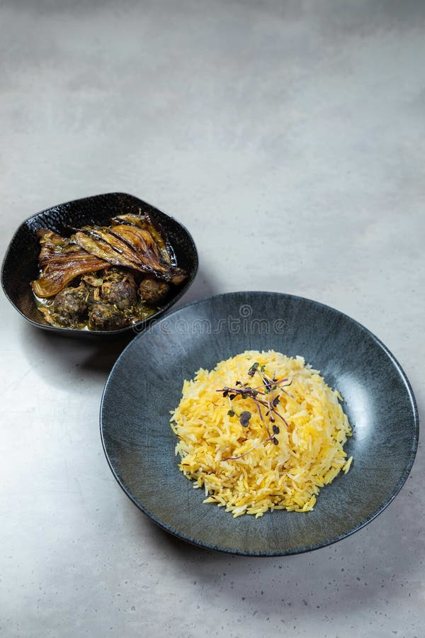 Saffron Rice and Eggplant Being Served on a Modern Restaurant Table ...