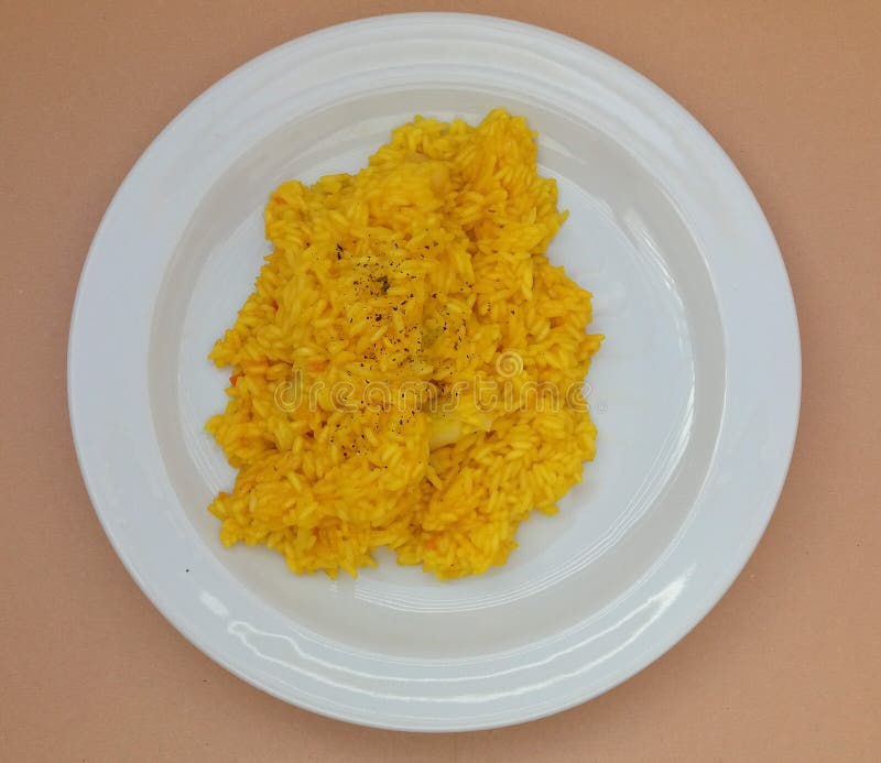 Saffron risotto in a dish stock image. Image of pepper - 79403883