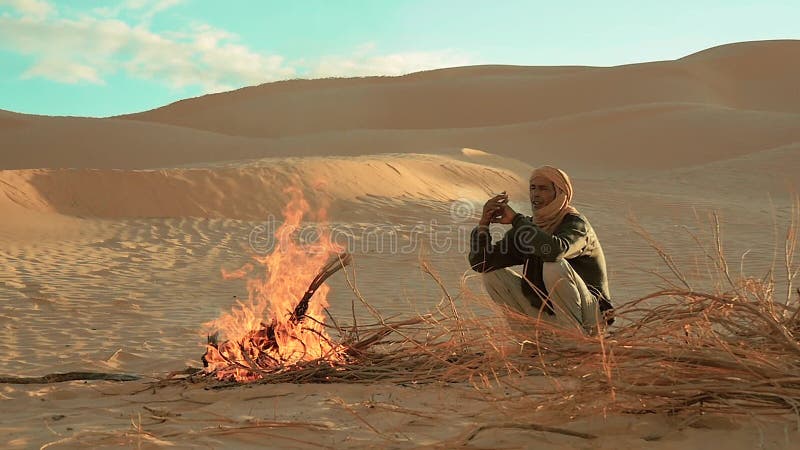 Sahara man near a fire stock footage. Video of adventure - 62953946