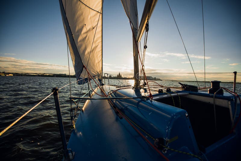 Sail Boat with Set Up Sails Gliding in a Sea or River at Sunset Stock ...