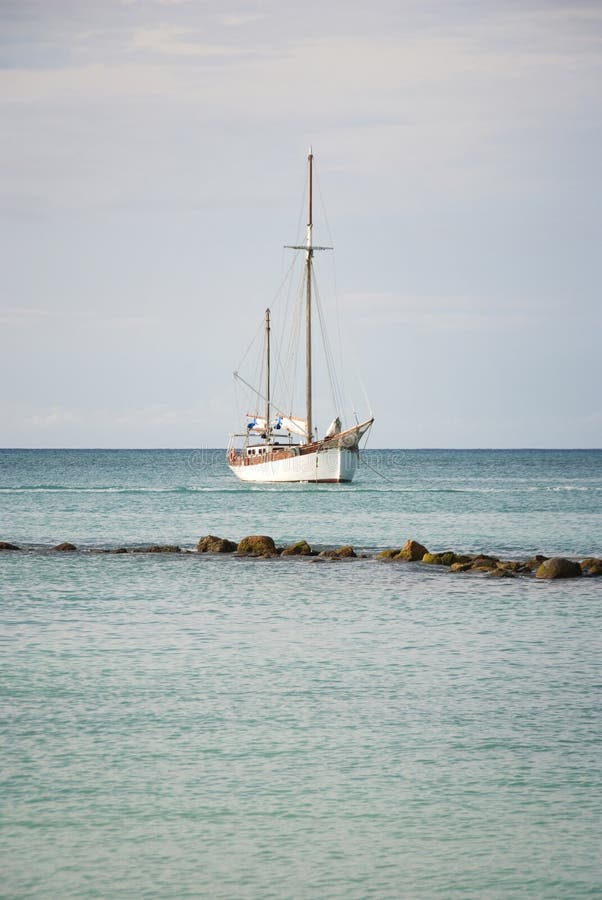Sailboat Anchored Off Shore Stock Photo - Image of ocean, holiday: 17129708