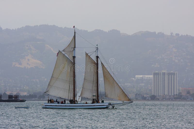 A sailboat on a bay stock image. Image of hills, large - 22254241