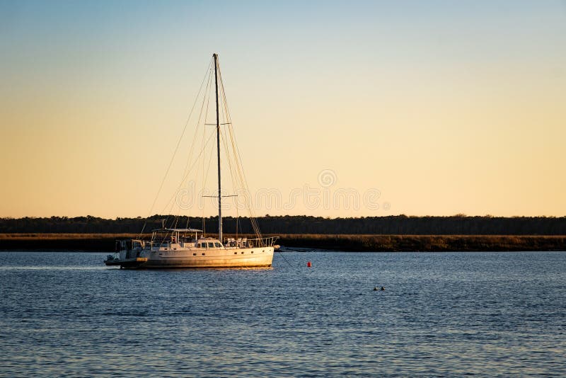 Sailboat on a Beautiful Golden Evening in a Bay Stock Photo - Image of ...