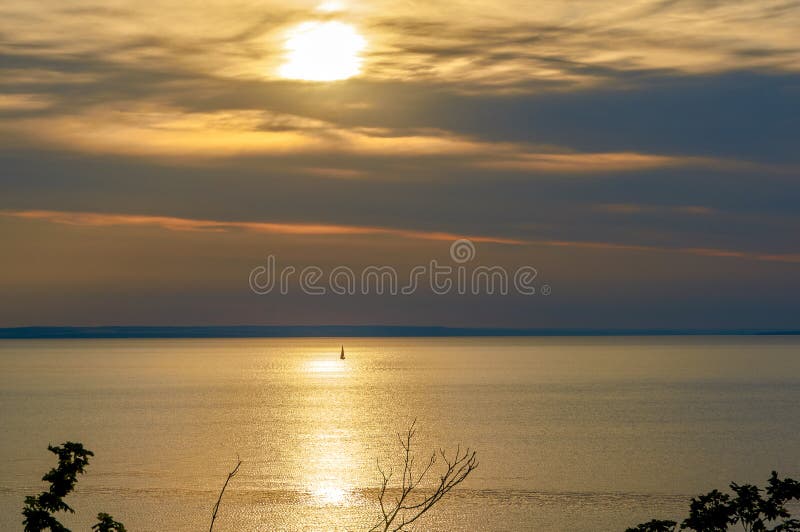 Sailboat in the Distance at Sunset in the Ocean Stock Image - Image of ...