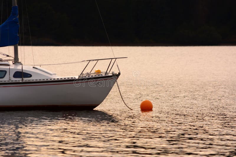 Sailboat Floating in a Body of Water, with an Orange Buoy in the ...